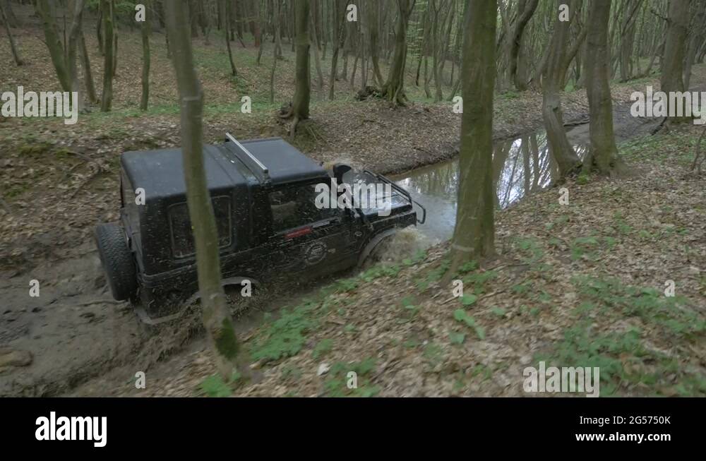 Jeep getting stuck in a mud puddle Stock Video Footage - Alamy