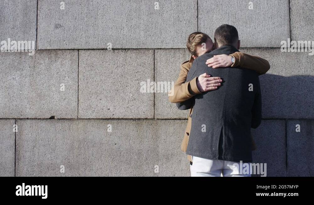 Camera reveals two men hugging each other in loving embrace - with ...