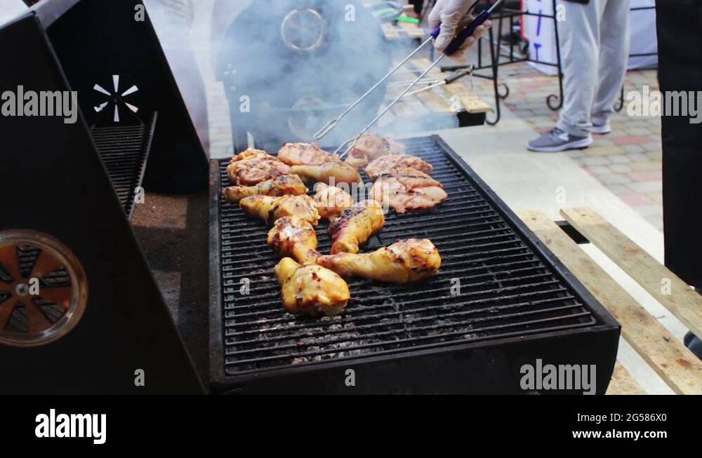 Chicken meat that turn over on a barbecue grill.Meat is fried in Mangal ...