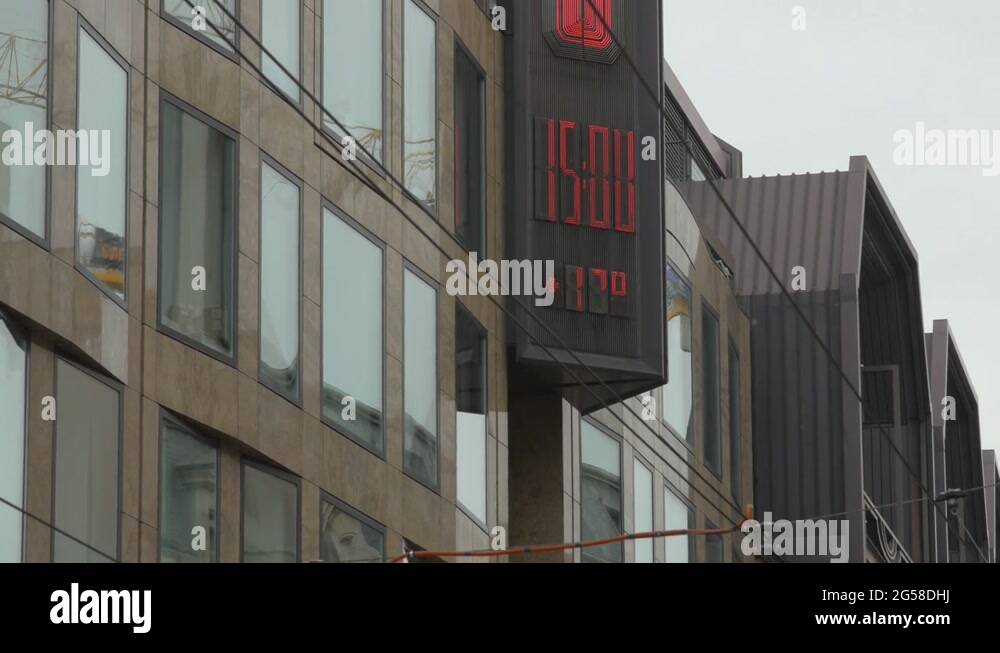 Tilt up of a digital clock on a building Stock Video Footage - Alamy