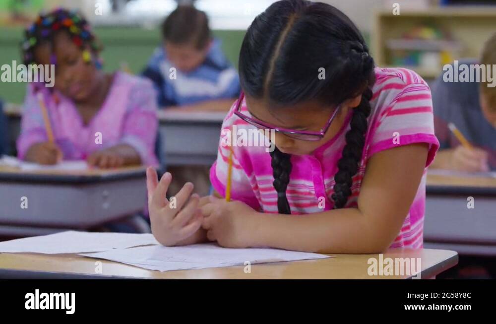 Students writing in school classroom Stock Video Footage - Alamy