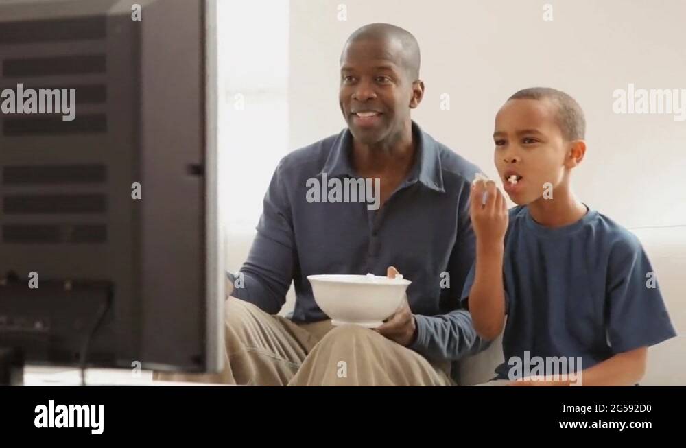 Father son watching tv together Stock Videos & Footage - HD and 4K Video Clips - Alamy