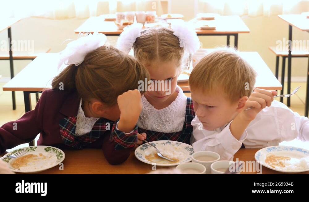 School food - a group of elementary school kids eating a school ...