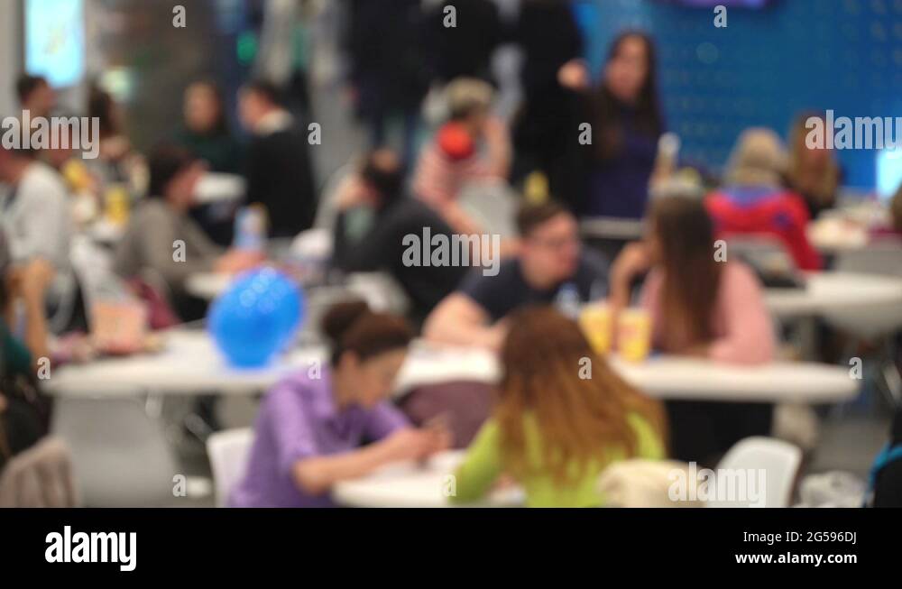 Concept junk food. Unrecognizable people eating fast food in mall food ...