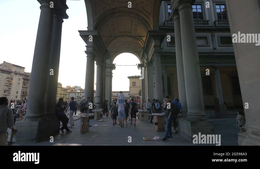 People walking under a building portico Stock Video Footage - Alamy