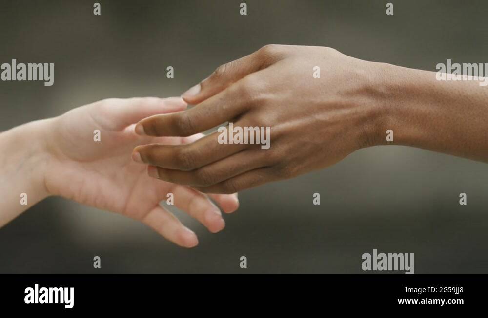 Two diverse hands come together for a handshake, in slow motion Stock ...