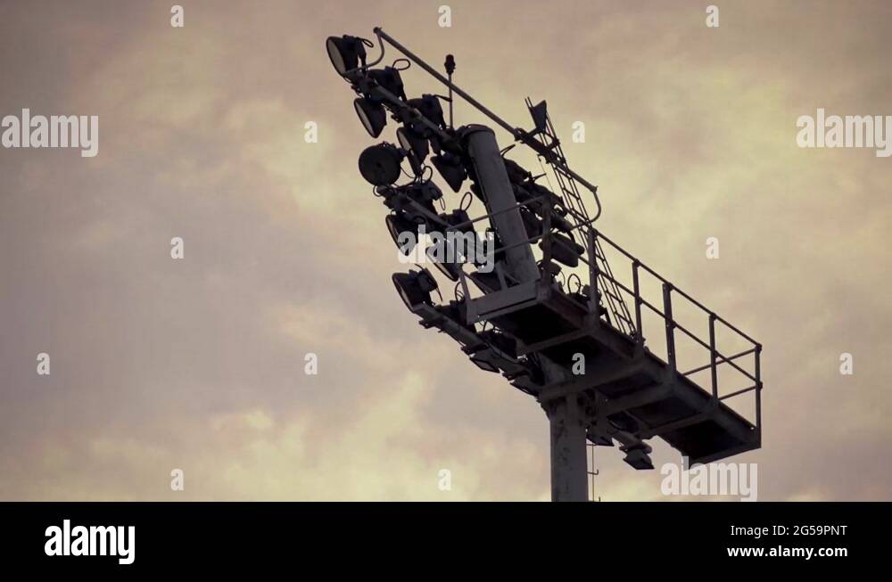 4K sports stadium lights in sunset sky and clouds background Stock ...