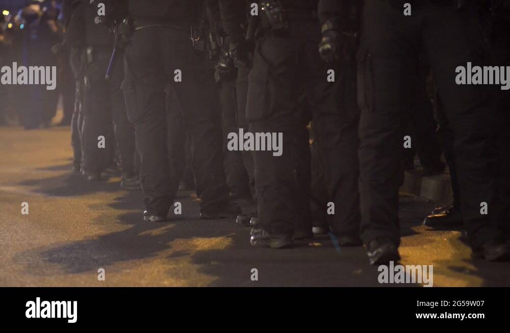 Riot police officer team, armored boots, night time Berlin, Germany ...