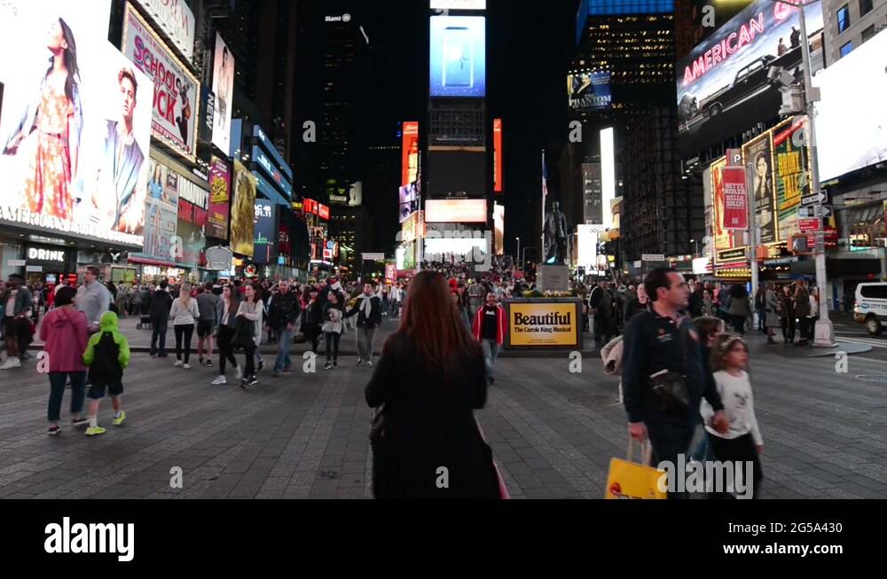 Times Square montage at night of pedestrians walking, New York, USA ...
