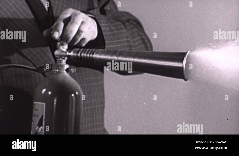 Man Using Fire Extinguisher on Fire 1960s Vintage Film Retro Industrial ...