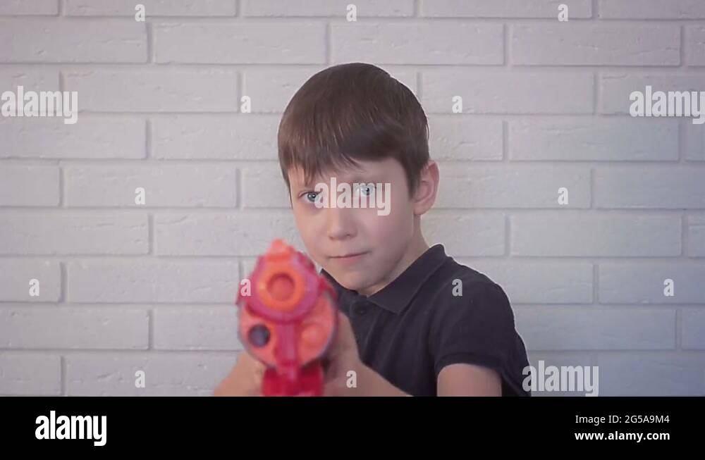 Young boy with gun Stock Videos & Footage - HD and 4K Video Clips - Alamy