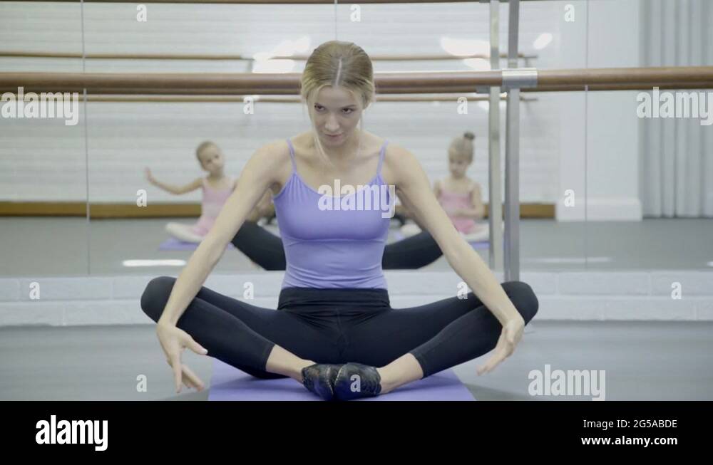 Teacher in children's dance school shows children movements of hands ...