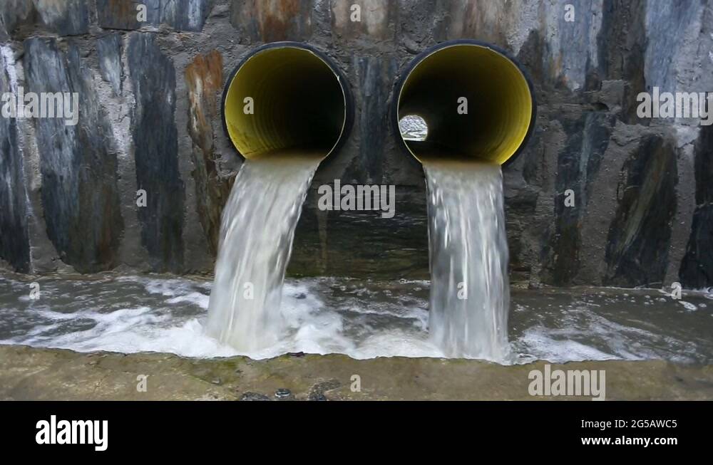 Drain waste. Waste is drained through pipes into a ditch. Environmental ...