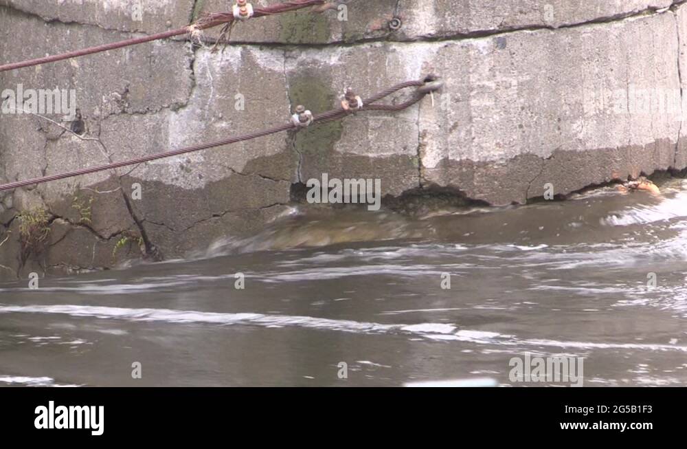 Crumbling dam and spillway infrastructure and fast flooding flood water ...