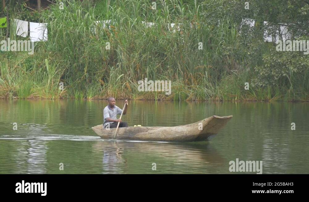 African man rowing a boat Stock Video Footage - Alamy