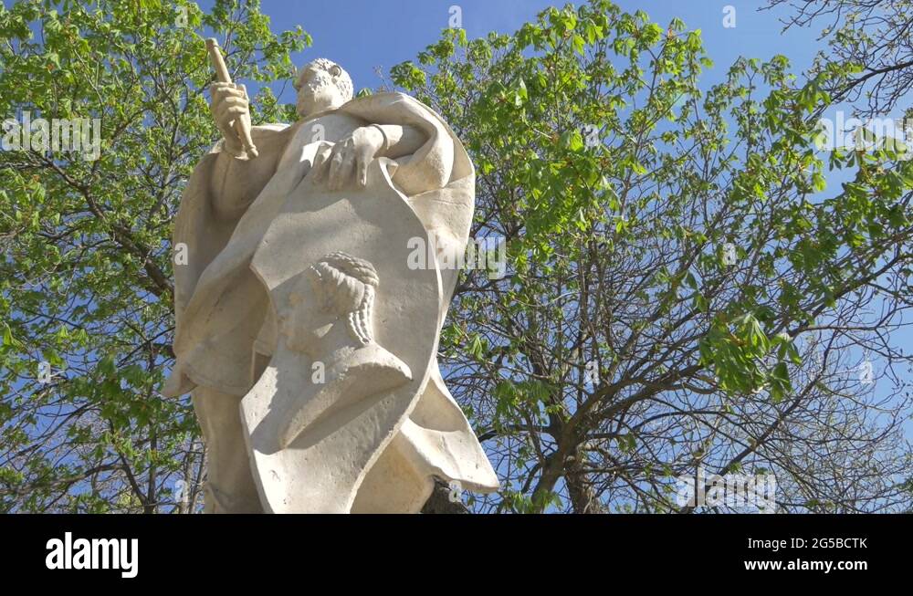 Low angle of a Man holding a scroll statue Stock Video Footage - Alamy