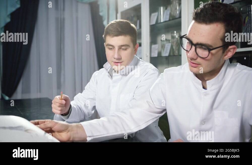 Medical students are thinking and reading anatomy textbook Stock Video ...