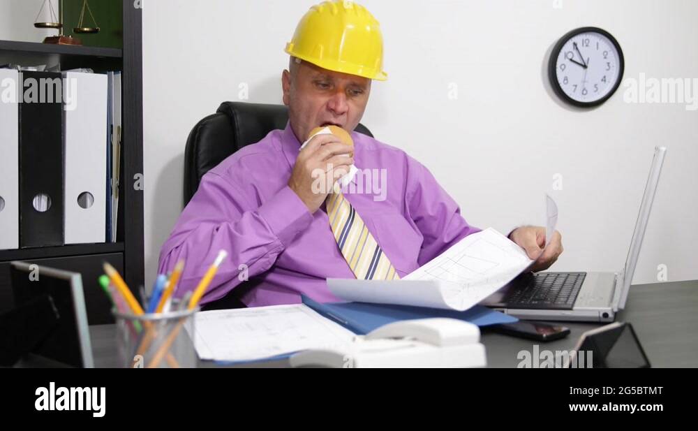 Inside Office Lunch Time Engineer Eat Sandwich Reading a Project at Job ...