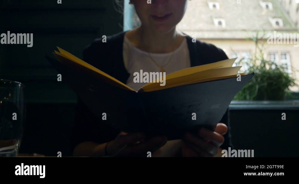 Woman choosing food from menu at restaurant Stock Video Footage - Alamy