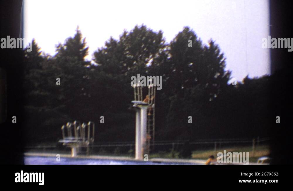NEW YORK-1973: View Of Person Standing On Diving Board Of Swimming Pool ...