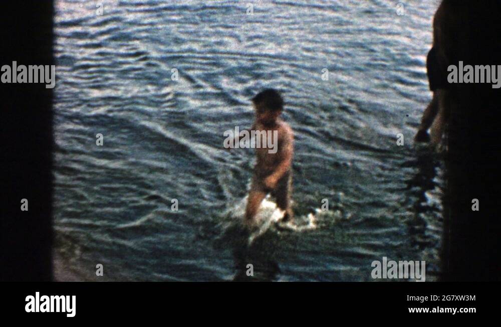 WISCONSIN-1957: Boy Coming Out Of The Water With A Face Of Being Cold ...
