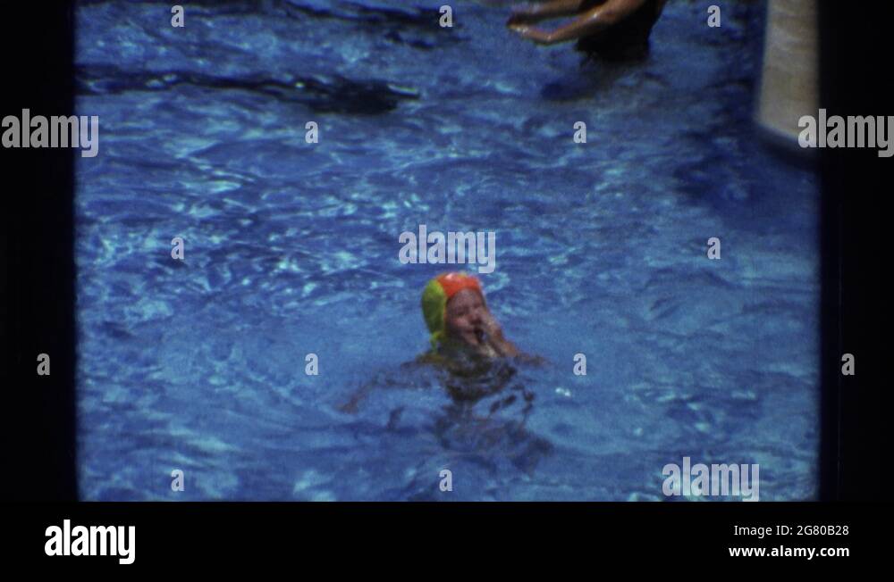 NEW YORK-1973: Girl Swimming In Pool With A Colorful Cap Holding Nose ...