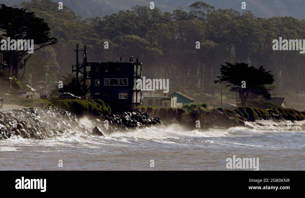 Ocean waves crash into a beach and rocky cliffs Stock Video Footage - Alamy