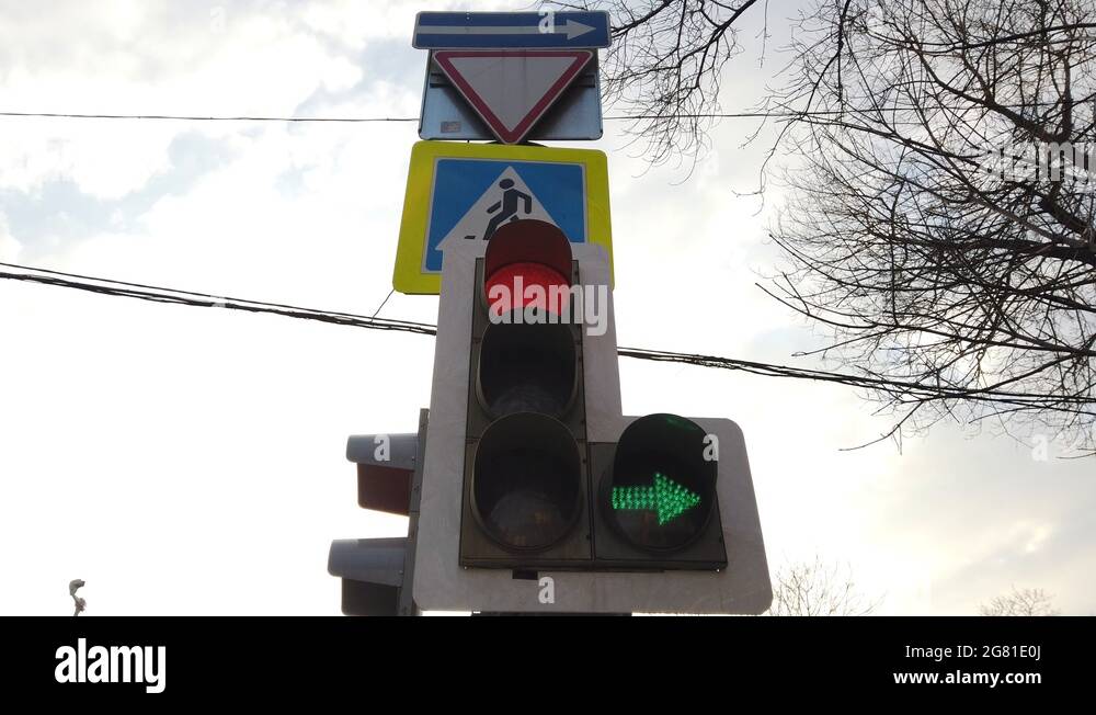 Traffic lights red, yellow, green, green arrow. Sign give way ...