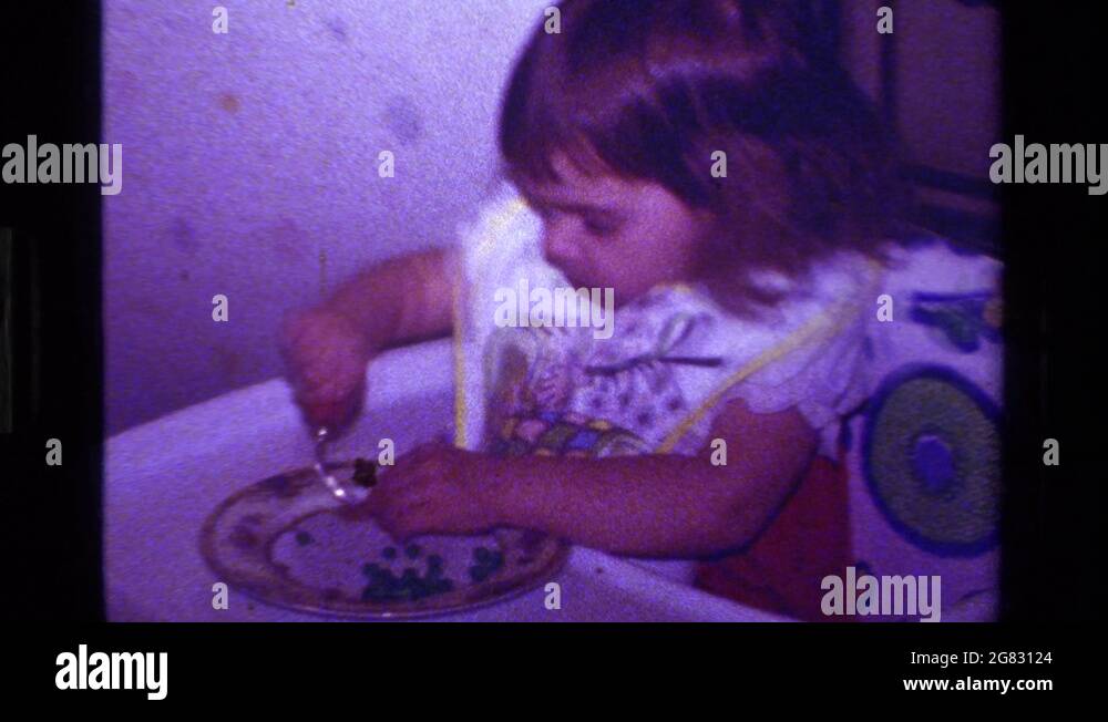 CALIFORNIA USA-1979: Baby Girl Sitting In Stool Eating Peas From A ...