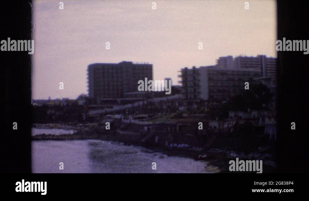 SPAIN-1972: City Next To Ocean Waves Large Buildings With Rocks In The ...