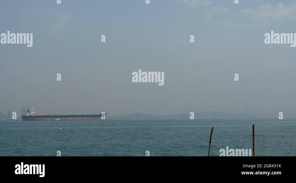 4k Huge container oil tanker ship on ocean,modern building background ...