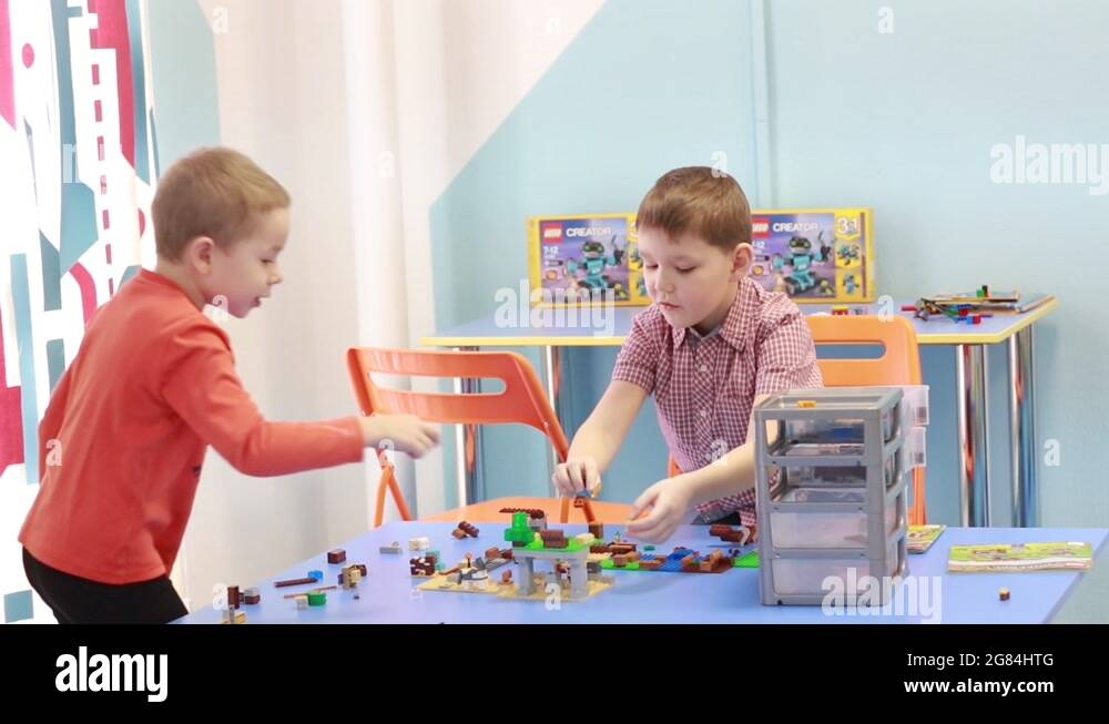 two children play LEGO, build a city Stock Video Footage - Alamy