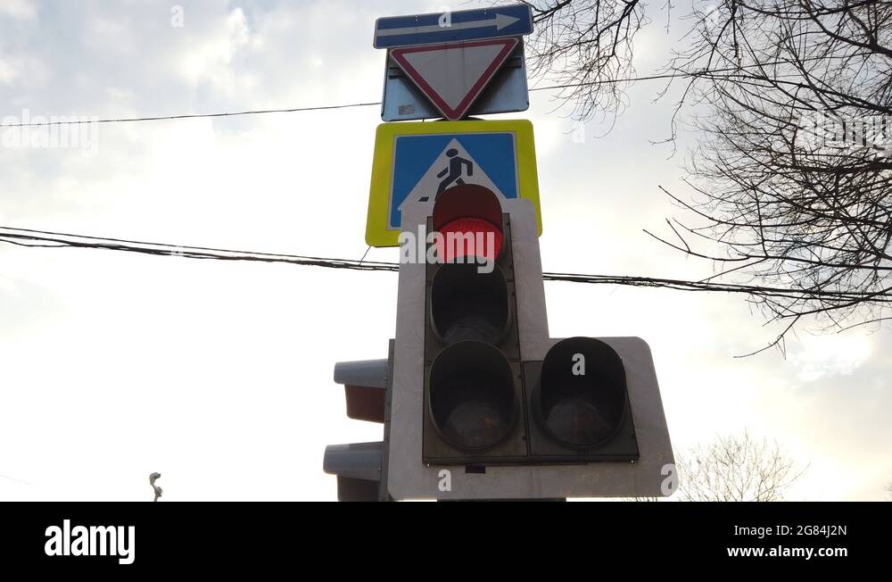 Traffic lights red, yellow, green, green arrow. Sign give way ...