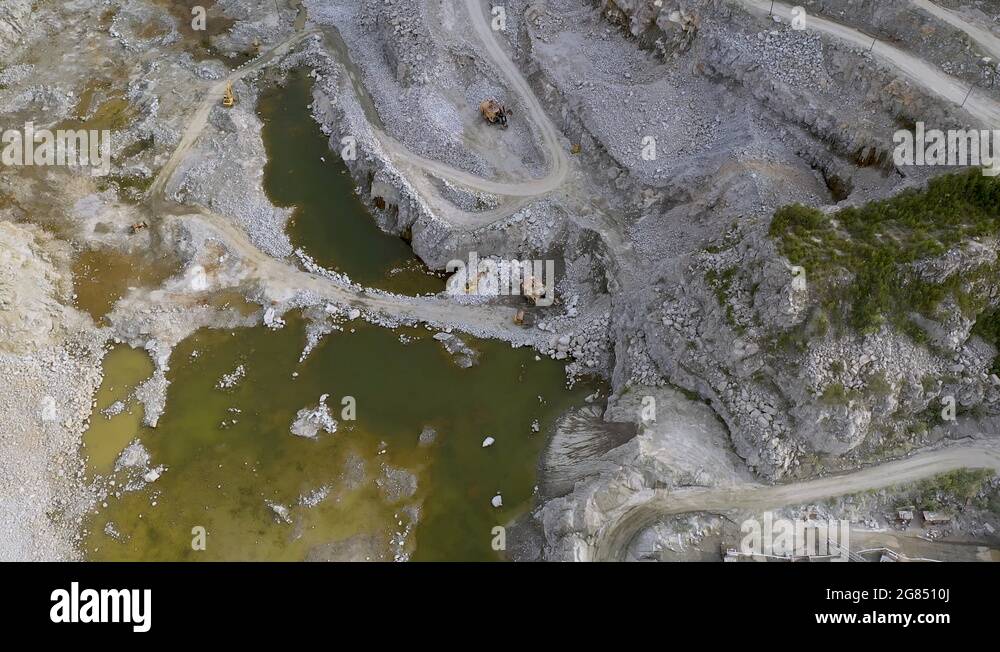 Mining dump trucks in open pit mine. Loaded truck rides on the road ...