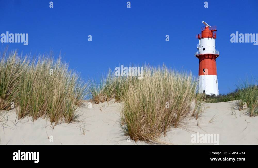 Dunes in front of a Lighthouse on frisian small holiday island Borkum ...