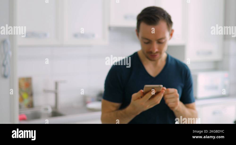 Amazedly man showing empty green screen of smart phone at home with ...