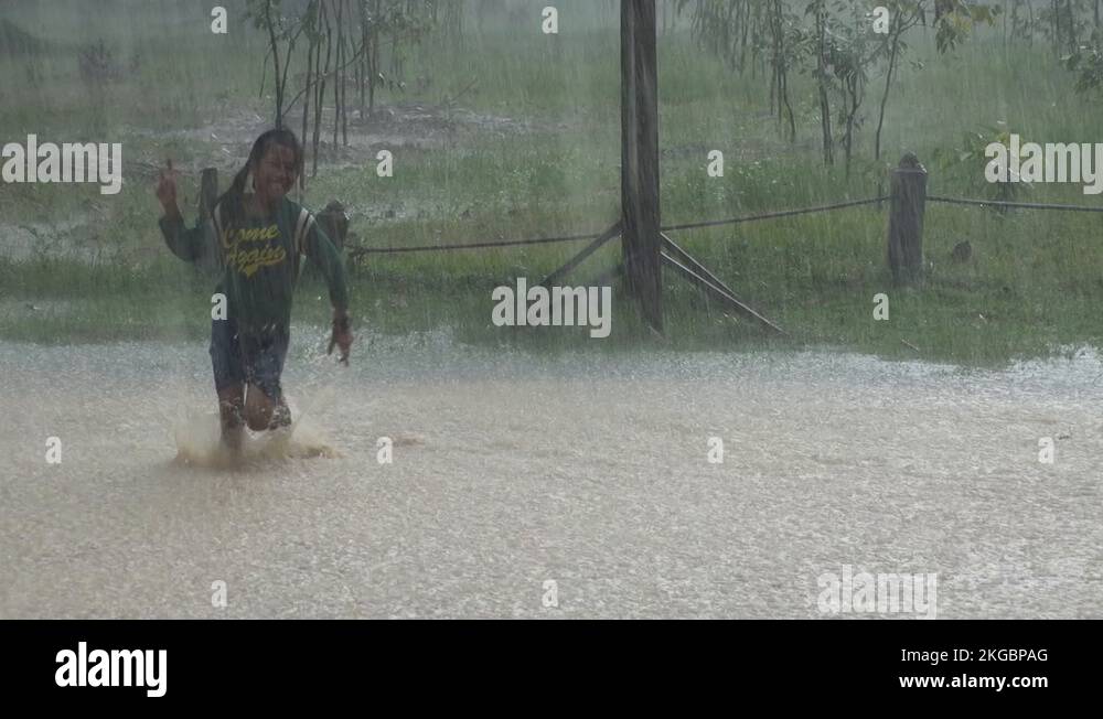 SIEM REAP, CAMBODIA : CHILDREN PLAYING in HEAVY RAIN Stock Video ...