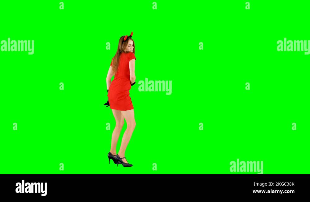 Devil Girl in Tight Red Dress Teasing and Sending Kisses on Green ...