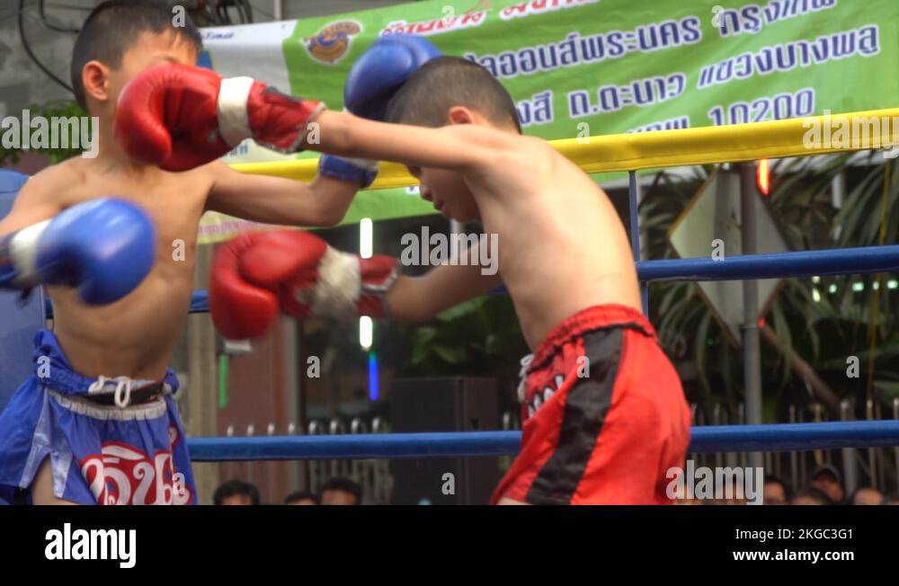 Young Muay Thai boxers fighting on stage during a festival in Bangkok ...