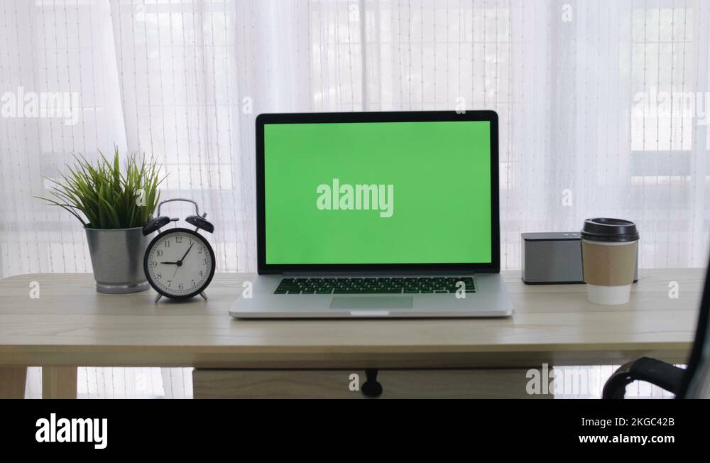 4K Green screen of laptop computer set on working space in cozy office ...