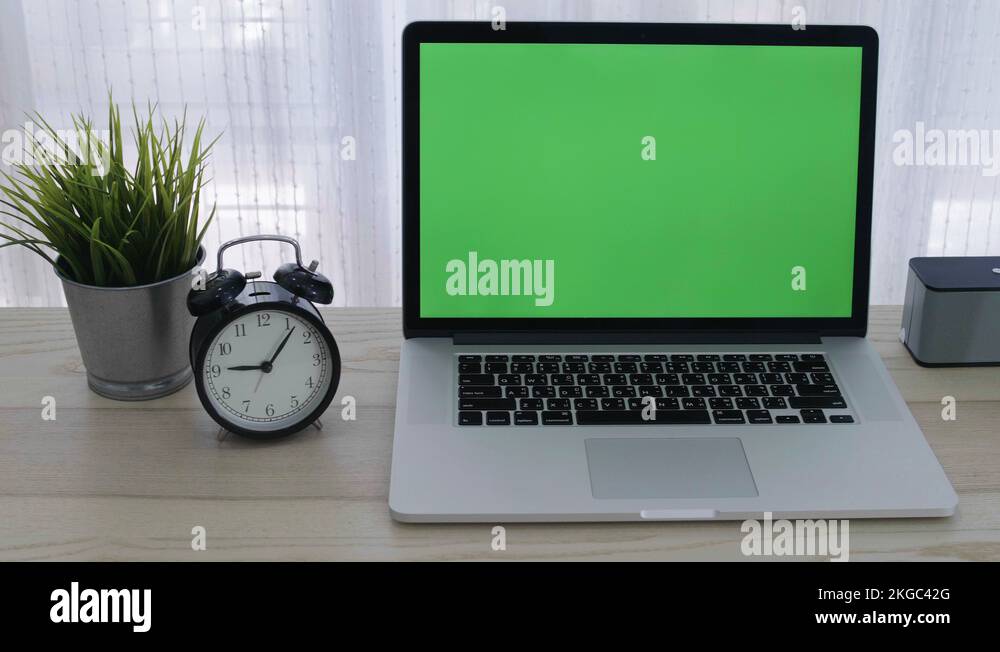 4K Green screen of laptop computer set on working space in cozy office ...