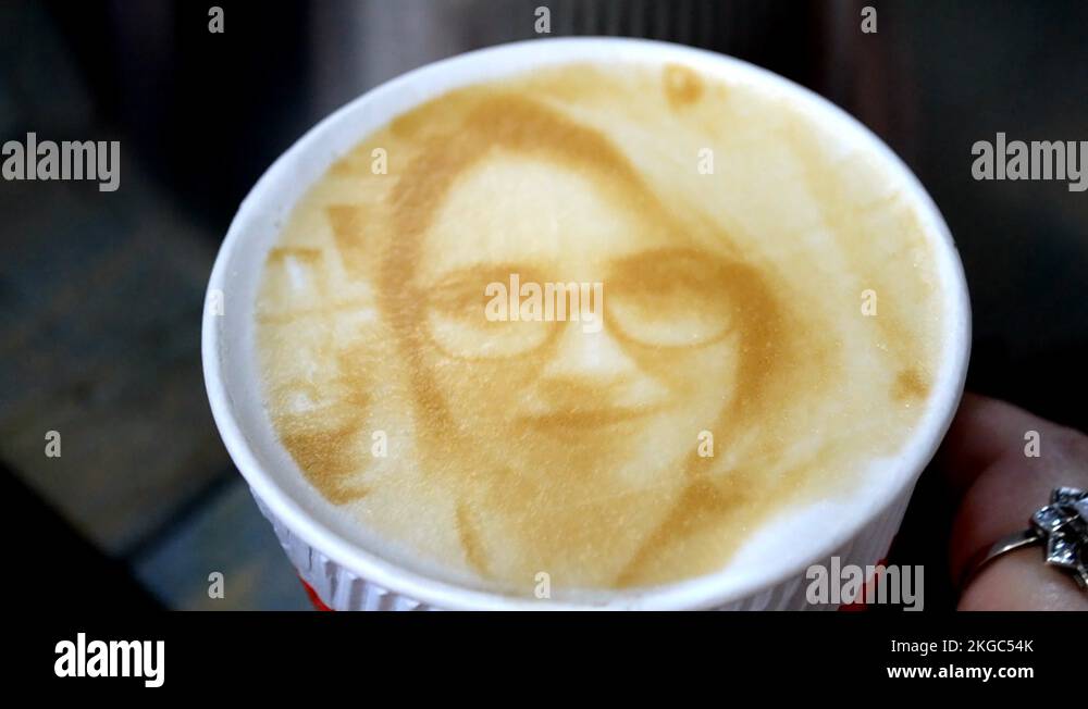 Drawing of a woman's face on a foam coffee latte created by a 3D ...