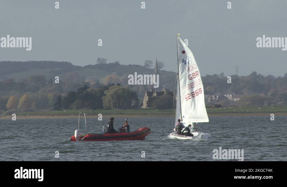 Sail training - dinghy does loops around a RIB on Rutland Water Stock ...