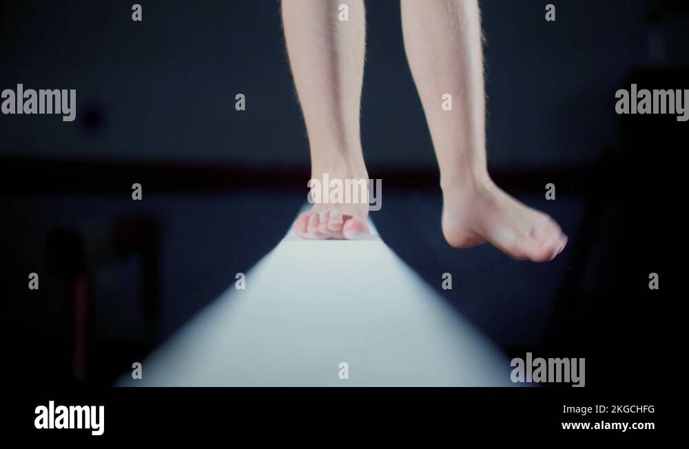 Little girl gymnast feet practicing balance on the beam for the ...