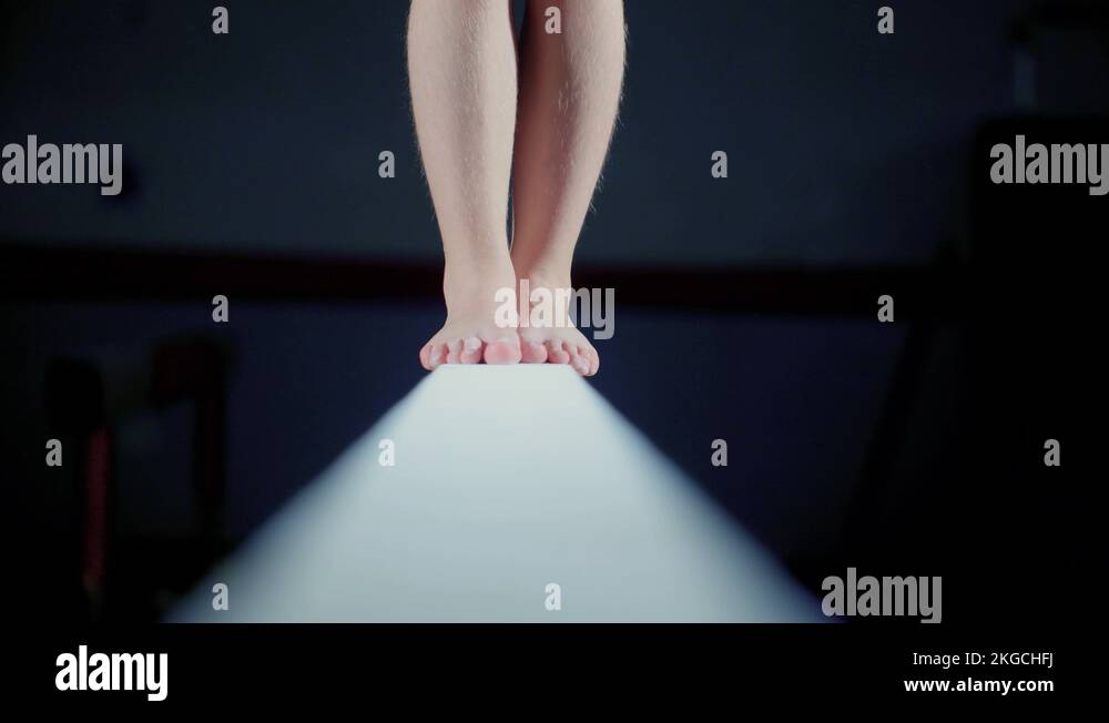 Little girl gymnast feet practicing balance on the beam for the ...