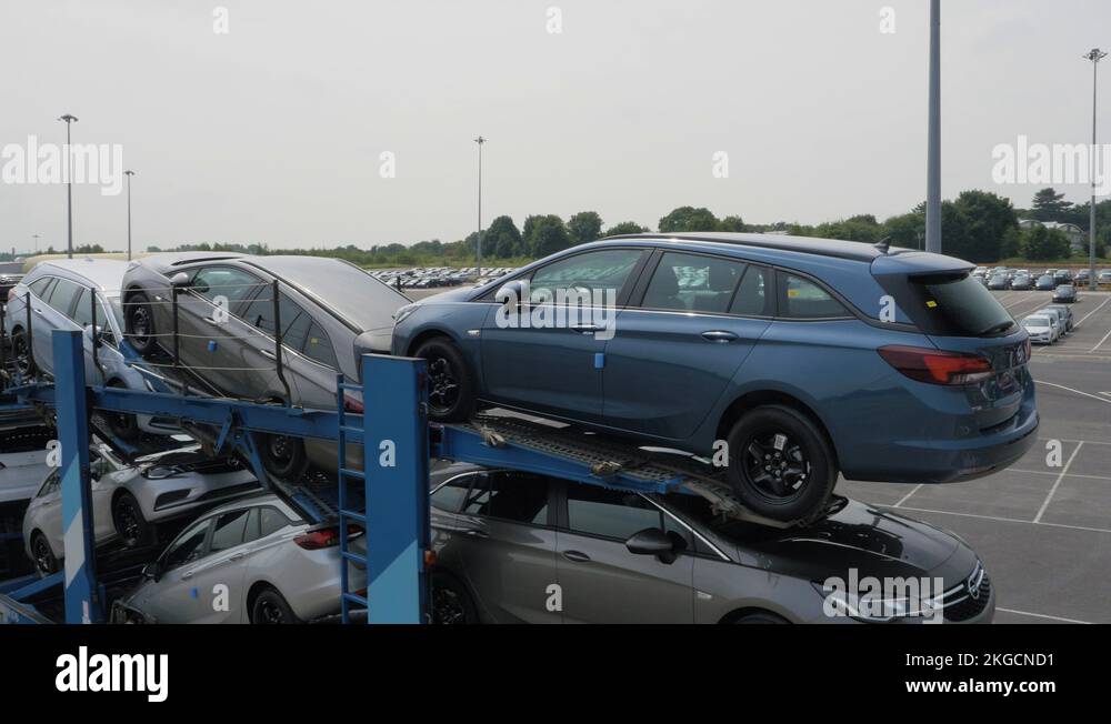 Cars being transported on the back of a large truck, drone aerial 4K ...
