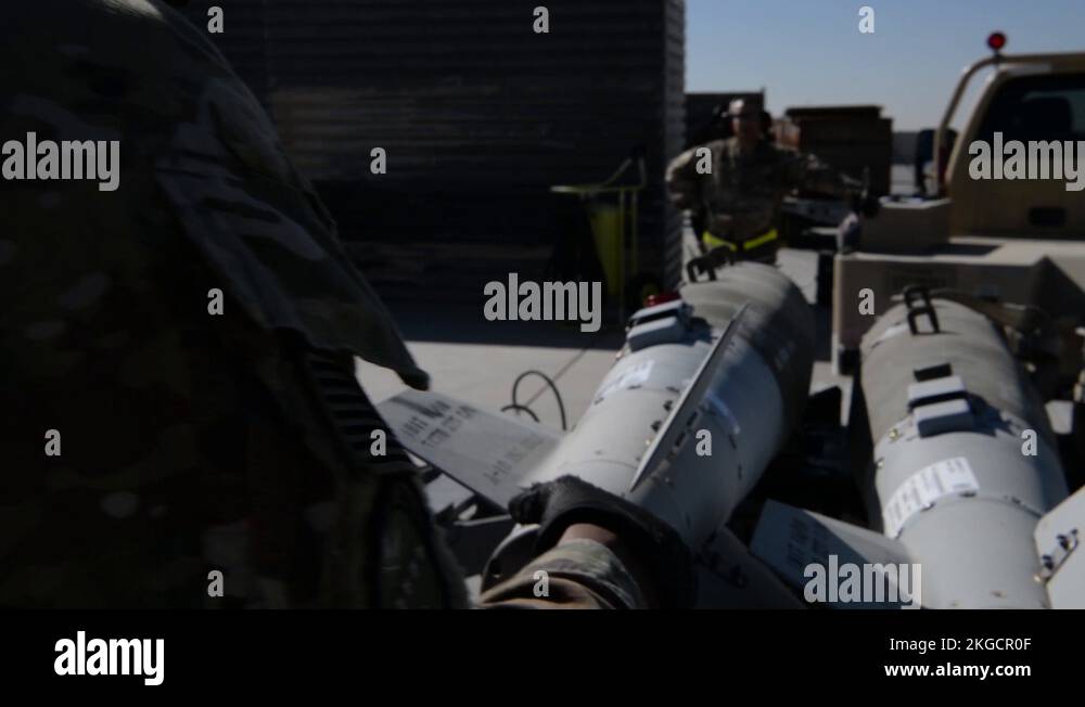 Maintainer loading missile onto bomb loader for A-10 Thunderbolt II ...