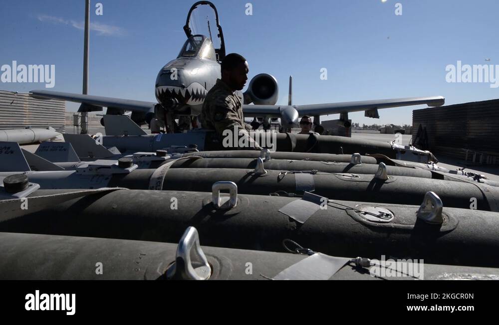 Maintainer loading missile onto bomb loader for A-10 Thunderbolt II ...