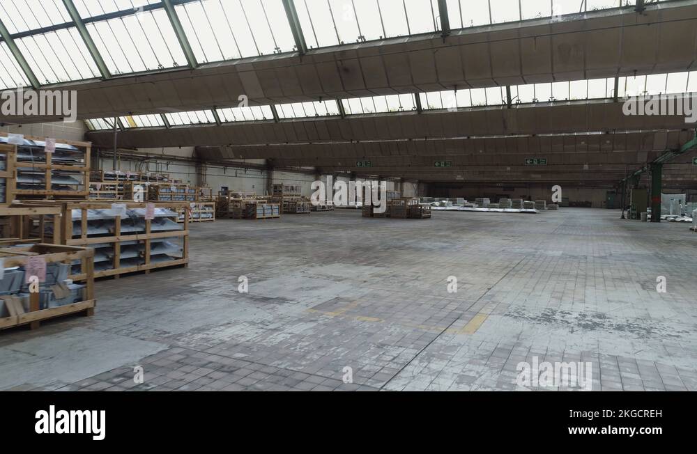 Generic long industrial warehouse with random inventory, drone aerial ...