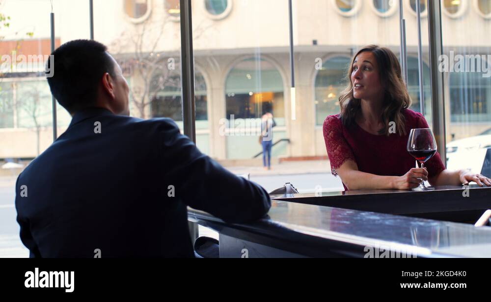 Business people interacting with each other at bar counter in hotel 4k ...